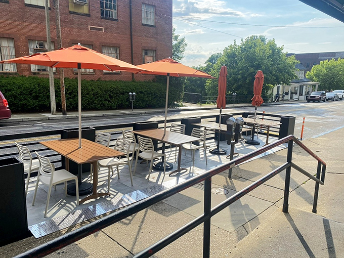 Summer dining al fresco under bright orange umbrellas—because sometimes pancakes taste even better with a side of sunshine and people-watching.