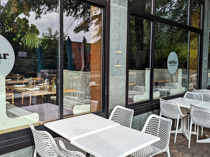 The outdoor seating offers a front-row view of Clarendon life. Those minimalist white tables are blank canvases awaiting colorful Balkan masterpieces.