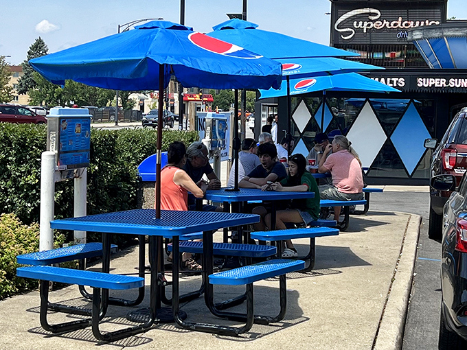 Summer in Chicago means outdoor tables, Pepsi umbrellas, and the democratic notion that the best meals sometimes happen on simple metal benches.