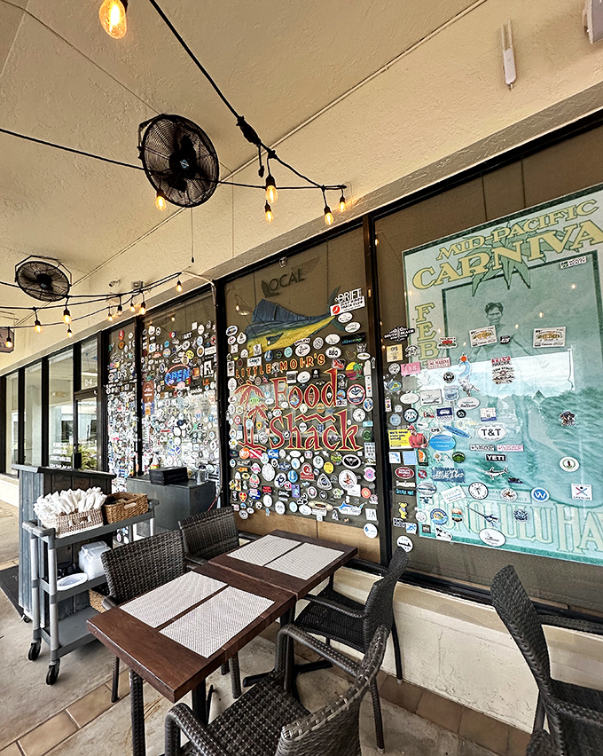 The covered patio, where string lights and ceiling fans create the perfect Florida dining microclimate, rain or shine.