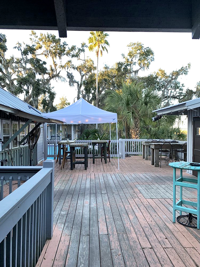 The weathered deck offers outdoor dining where palm trees and sea breezes provide the perfect ambiance.
