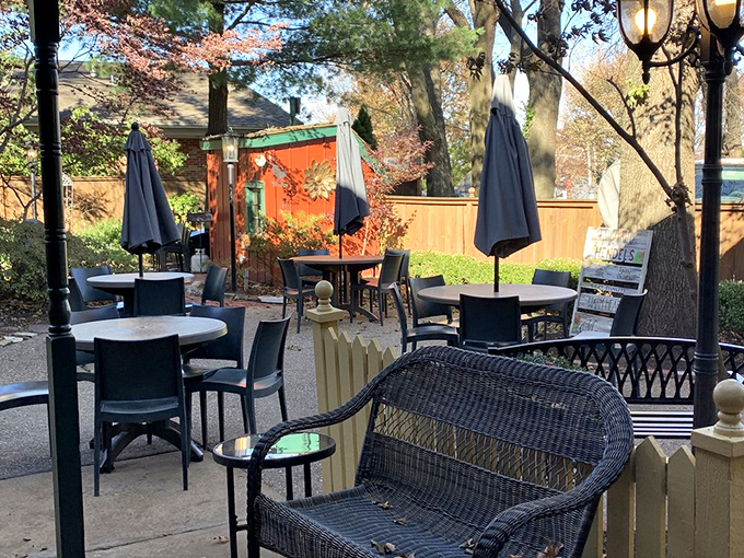 The outdoor patio, dappled with autumn colors and shaded by mature trees, turns an ordinary meal into an al fresco memory-making experience.