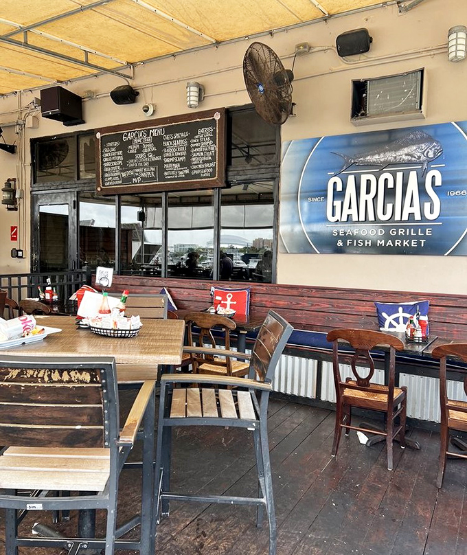 The outdoor patio, where nautical flags flutter overhead and the Miami breeze carries hints of grilled fish and ocean memories.