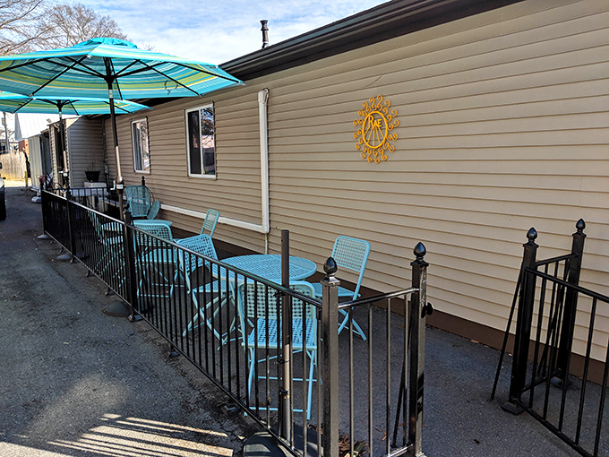 The outdoor patio: where you can pretend you're in a Parisian café while demolishing your third croissant. Those turquoise chairs have heard all the excuses.