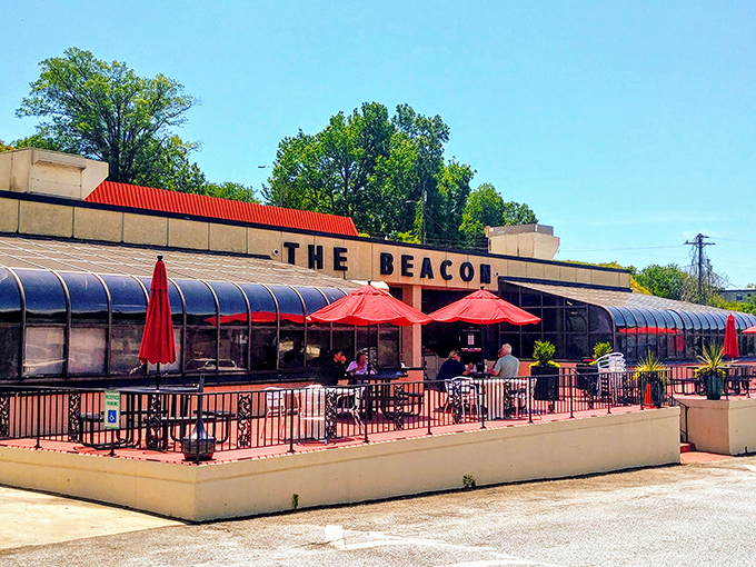 Outdoor seating where sweet tea tastes even sweeter. Those red umbrellas have shaded more meaningful conversations than any therapist's office.