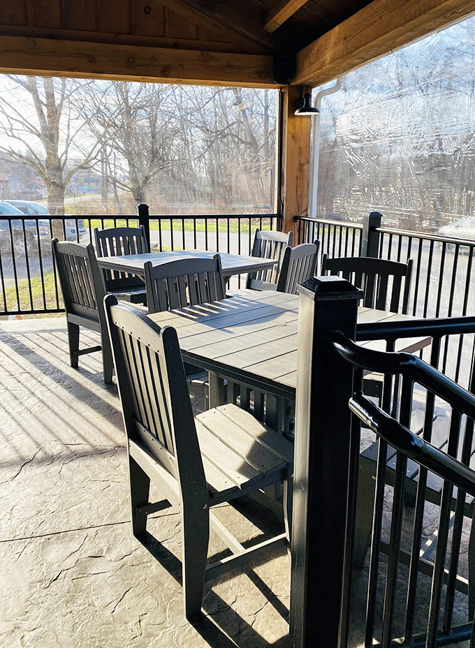 The covered porch offers three-season dining with a view of Ligonier's rolling landscape—nature's television with better programming.