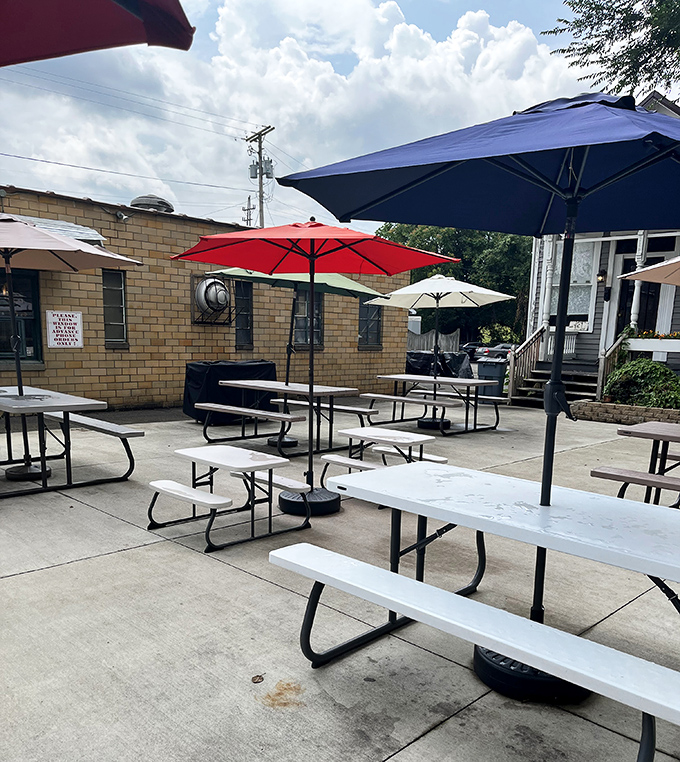 Summer seating that invites lingering conversations over melting masterpieces. Those colorful umbrellas provide shade for serious sundae contemplation.