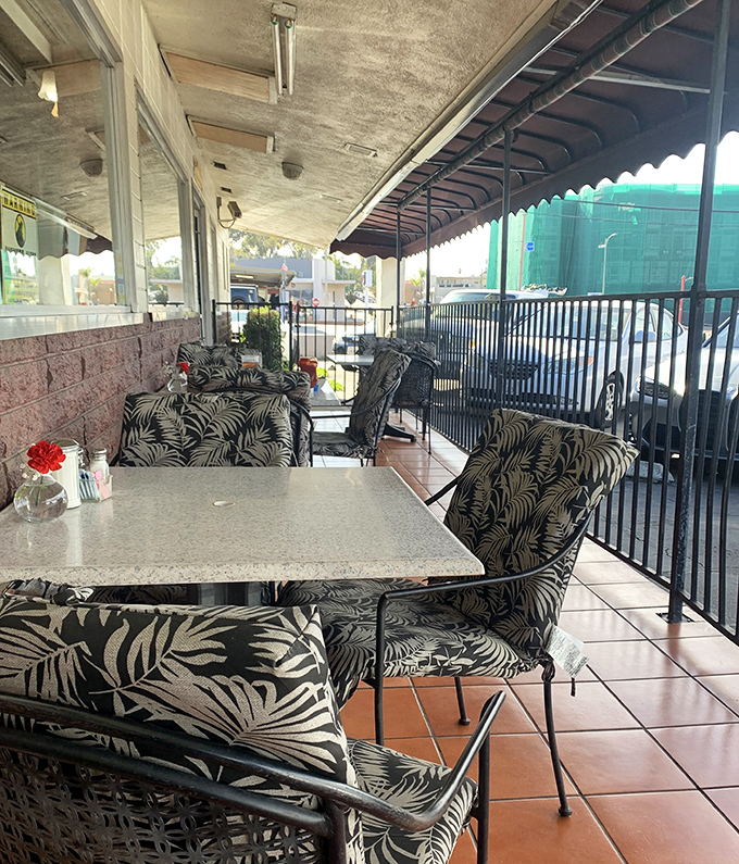 Outdoor seating with tropical-print chairs&mdash;because sometimes your chicken fried steak tastes better with a side of fresh air. 