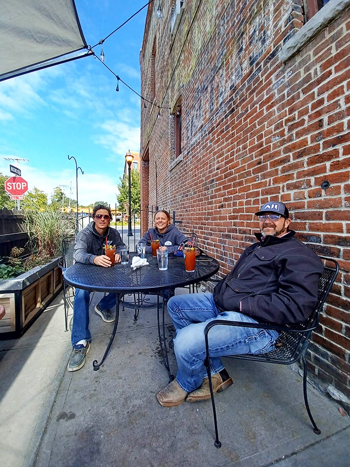 Sidewalk seating where Bloody Marys and friendship combine under Missouri skies &ndash; the perfect urban escape on a sunny day.