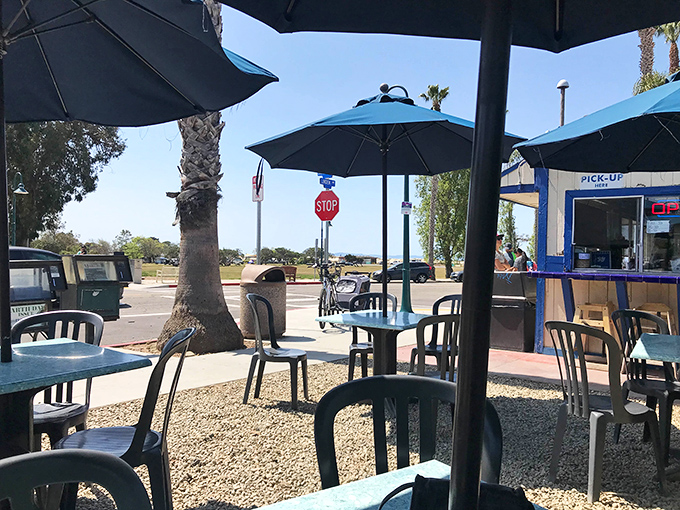 Blue umbrellas provide shade while you contemplate life's important questions, like "Should I have ordered the double instead of the single?"