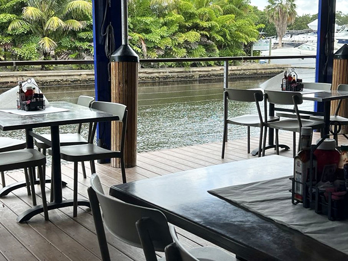 Waterfront tables offer the quintessential Florida dining experience: fresh seafood with a side of gentle breezes and passing boats.