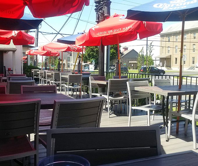 Red umbrellas dot the outdoor seating area like cherry tops on sundaes, offering a perfect perch for people-watching while you dine.