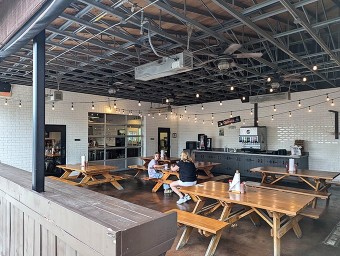 Picnic tables under string lights &ndash; because barbecue tastes 37% better when eaten outdoors while pretending you're at a fancy backyard party.