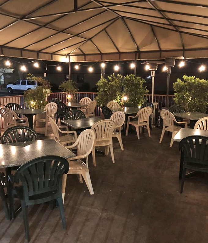 The outdoor seating area transforms into a twinkling oasis at night, where string lights create the perfect ambiance for enjoying dessert under the stars.