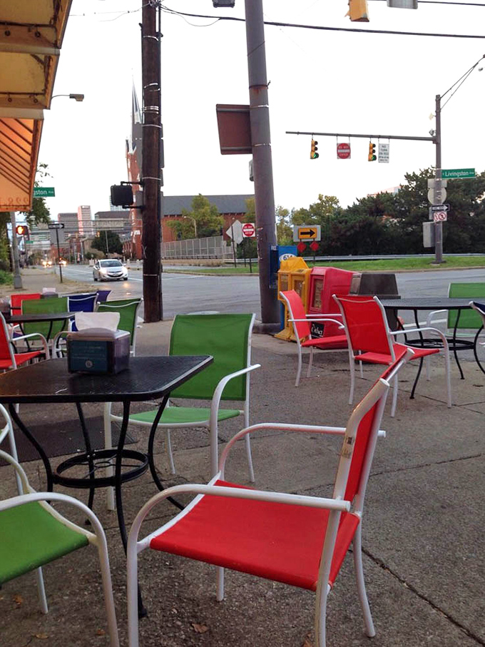 Colorful outdoor seating where the urban landscape becomes the perfect backdrop for contemplating the meaning of sandwich perfection.