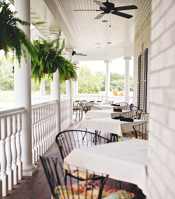 Porch seating that begs you to linger over coffee and dessert. Those hanging ferns aren't just decoration&mdash;they're part of the ambiance.
