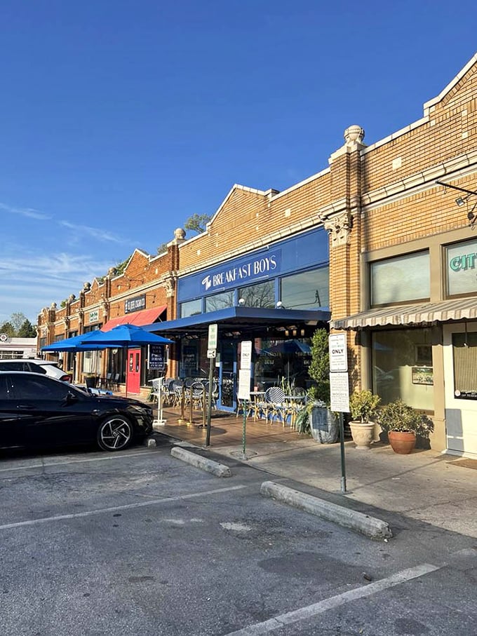 Historic brick and blue signage anchor The Breakfast Boys in the neighborhood, while the Florida sky provides the perfect backdrop.