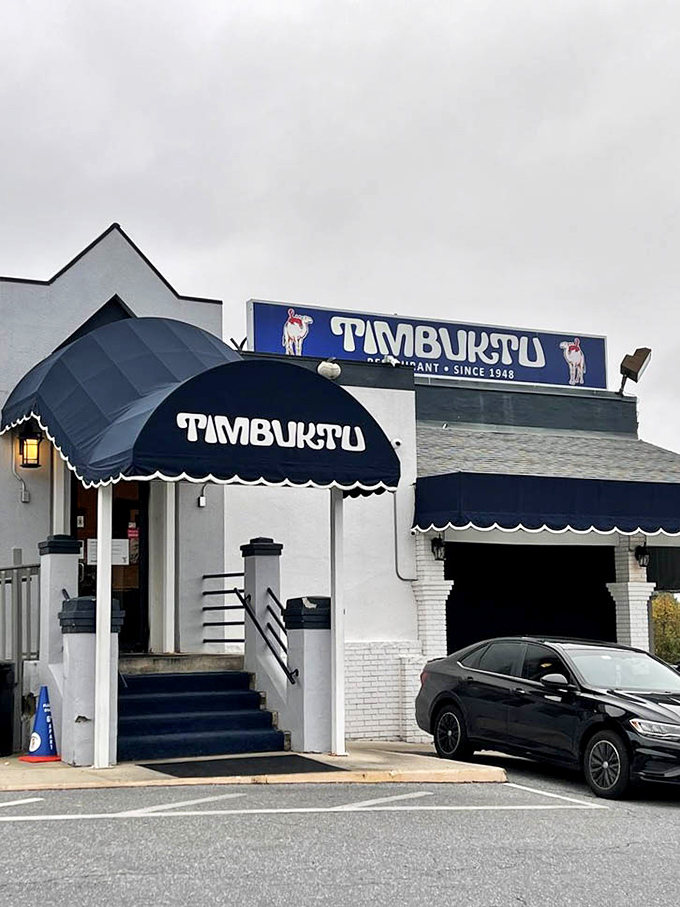 The restaurant's entrance, crowned with its signature blue awning, stands like a beacon for hungry travelers seeking authentic Maryland flavors.
