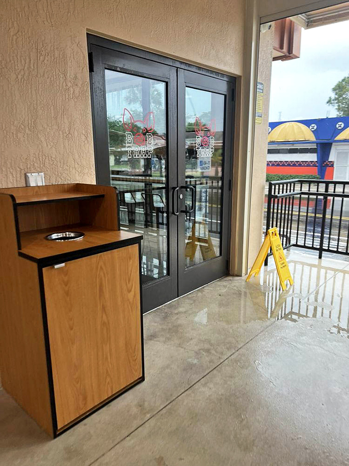 The entrance to meat paradise isn't pearly gates &ndash; it's glass doors with a pig logo. That yellow caution sign might as well say "Warning: Extreme Deliciousness Ahead."