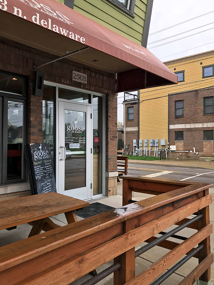 The unassuming entrance and outdoor seating area hide the culinary wonderland within—like finding a secret garden of gastronomic delights.