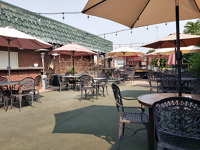 The outdoor seating area's ornate chairs and umbrellas create an oasis where afternoon drinks have been known to stretch pleasantly into evening meals.