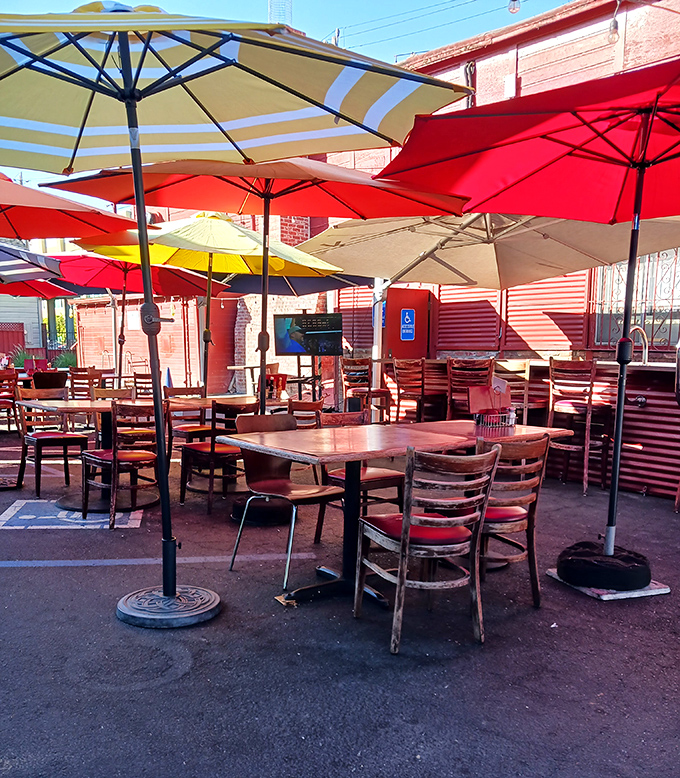 The outdoor seating area with its cheerful umbrellas offers a casual alternative for those who prefer their BBQ with a side of sunshine.