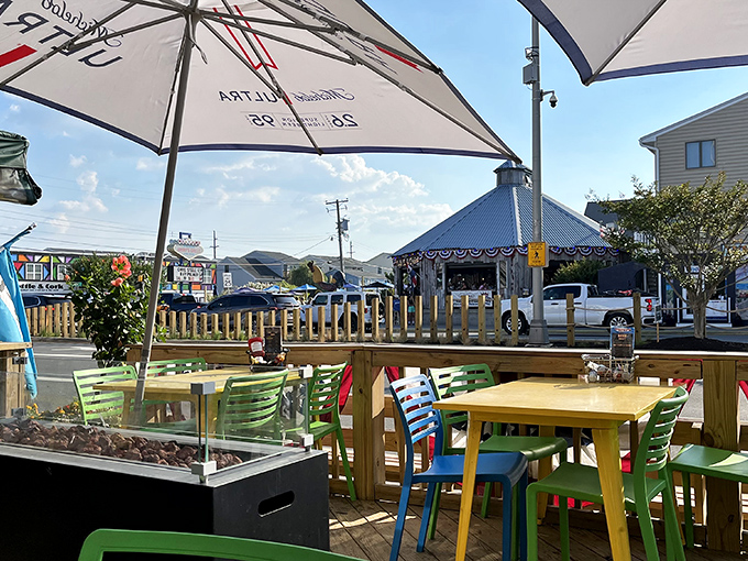 Colorful outdoor seating under market umbrellas&mdash;where the ocean breeze enhances every bite and summer seems eternal.