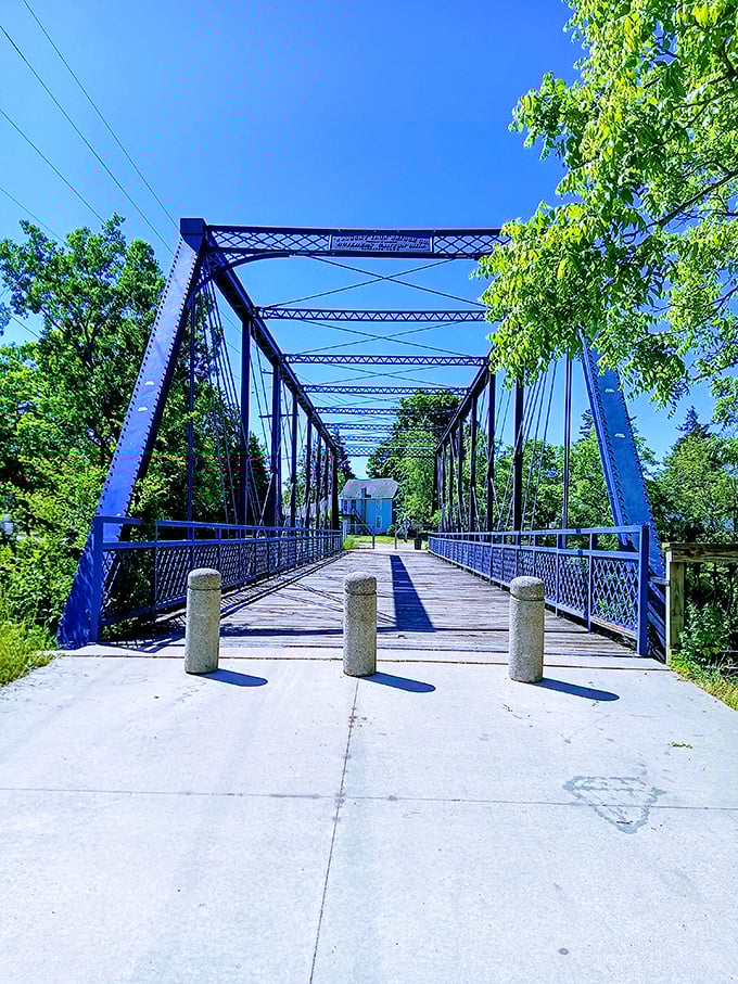 This blue bridge isn't just functional infrastructure &ndash; it's a pathway to Owosso's natural beauty, inviting exploration and peaceful wandering.