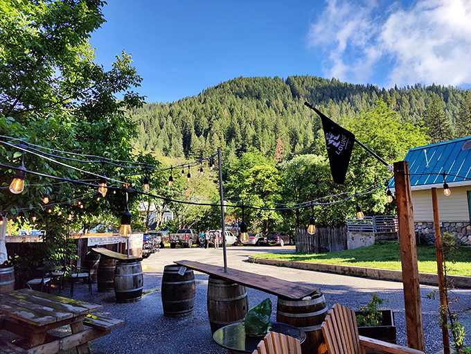 The outdoor gathering space with string lights and wine barrels creates the perfect setting for swapping trail stories as the mountain air cools.