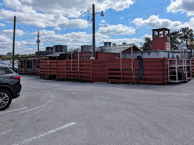 No fancy architecture or valet parking needed—just a gravel lot and a wooden fence that says, "We put our effort into the food, not the frills."