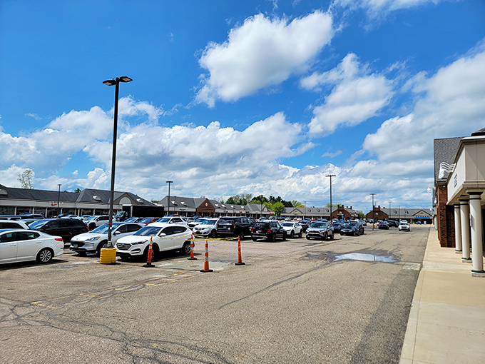 The parking lot fills with vehicles of determined shoppers. Each car represents someone who understands that saving money is actually making money.