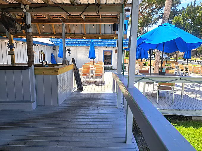 Outdoor seating bathed in sunshine and cooled by sea breezes. Those blue umbrellas match the water beyond—coincidence? I think not.