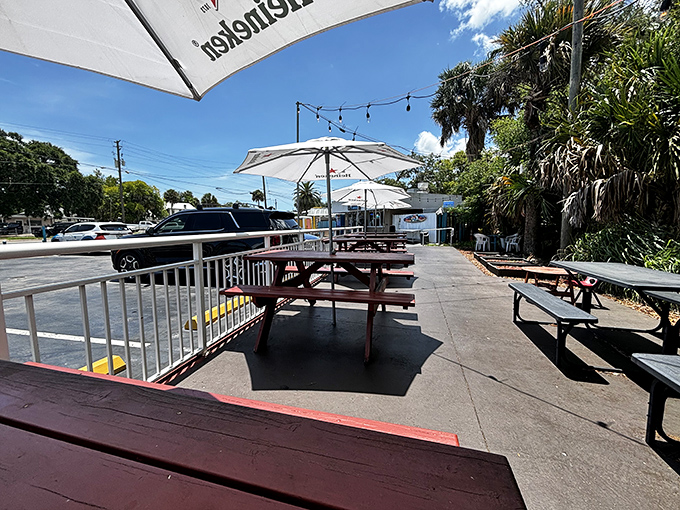 Red picnic tables under Florida skies create the perfect setting for devouring crispy chicken while watching the world go by.