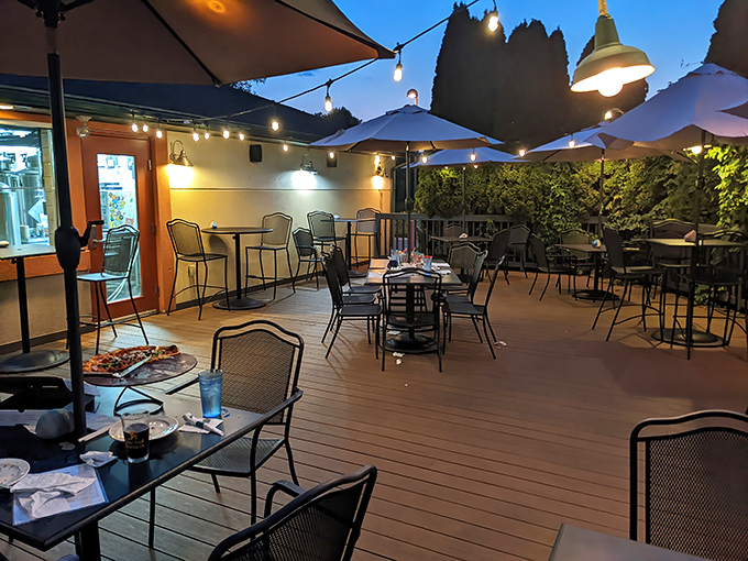 As the sun sets, the patio transforms into an enchanted garden where food tastes better and conversations flow like the string lights overhead.