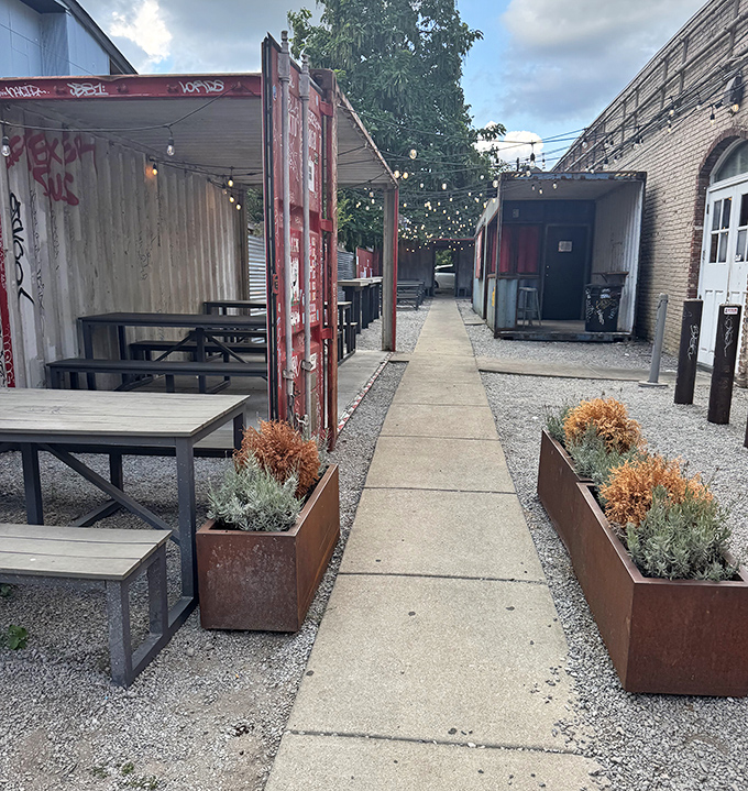 Outdoor dining with industrial charm. String lights overhead turn simple shipping containers into the coolest chicken patio in Kentucky.