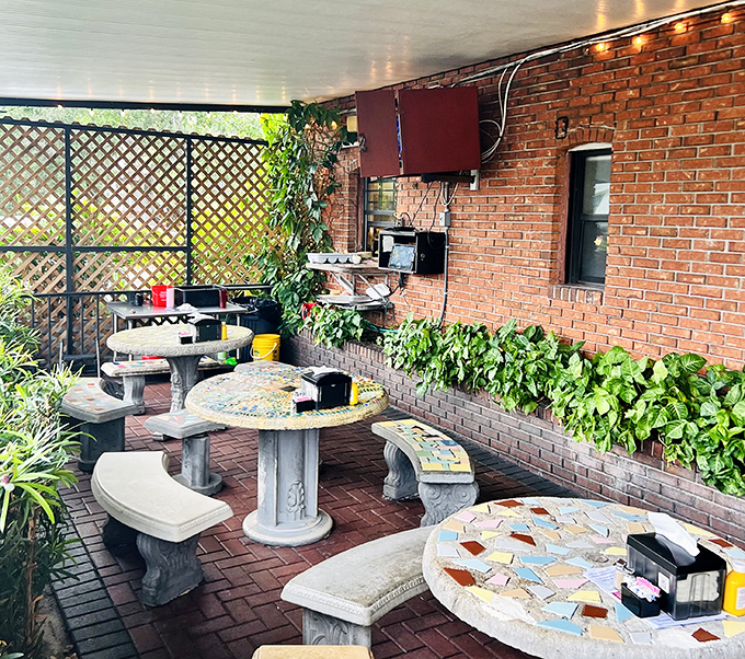 The patio offers a tranquil escape from Florida's heat. These mosaic tables have hosted countless conversations over cold beers and hot burgers. 