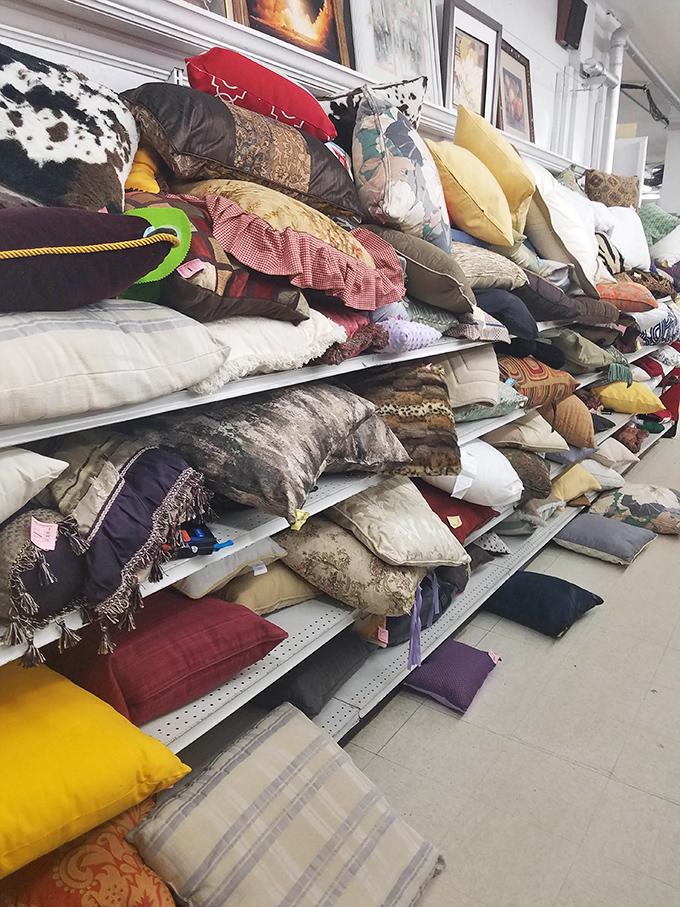 The pillow section resembles a textile mountain range, where decorative cushions from every decade wait to transform someone's couch from drab to delightfully eccentric.
