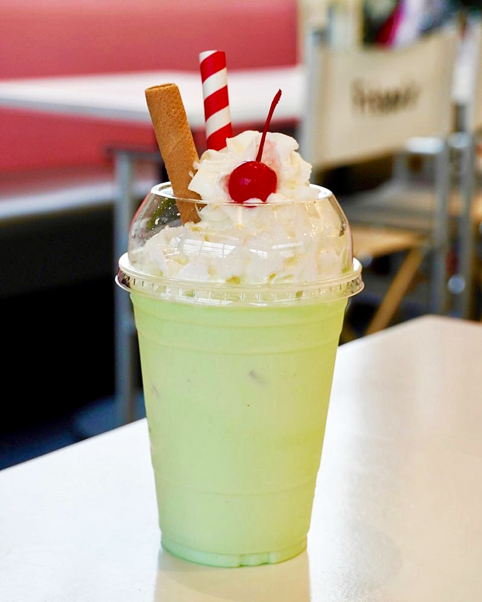 The pistachio almond milkshake &ndash; a pale green dream topped with whipped cream, a cherry, and a cookie. Dessert masquerading as a beverage.