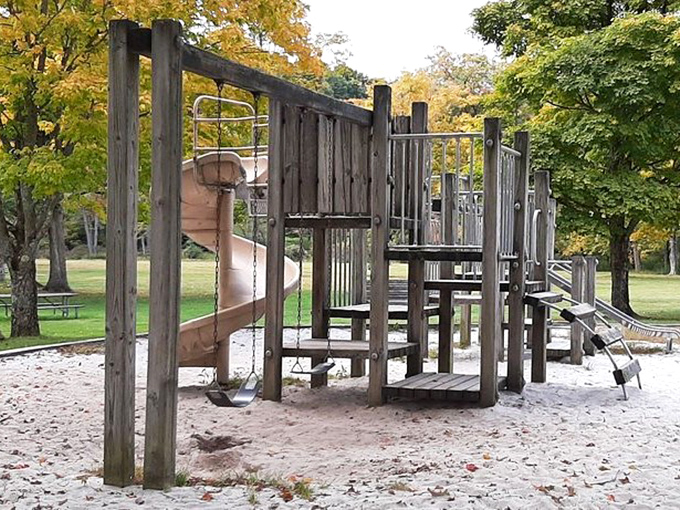 Playground equipment keeps little adventurers entertained while parents contemplate their next lakeside nap.