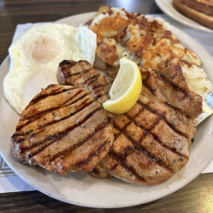 Pork chops for breakfast? Absolutely. Especially when they're grilled to this level of perfection and paired with eggs sunny enough to brighten your day.