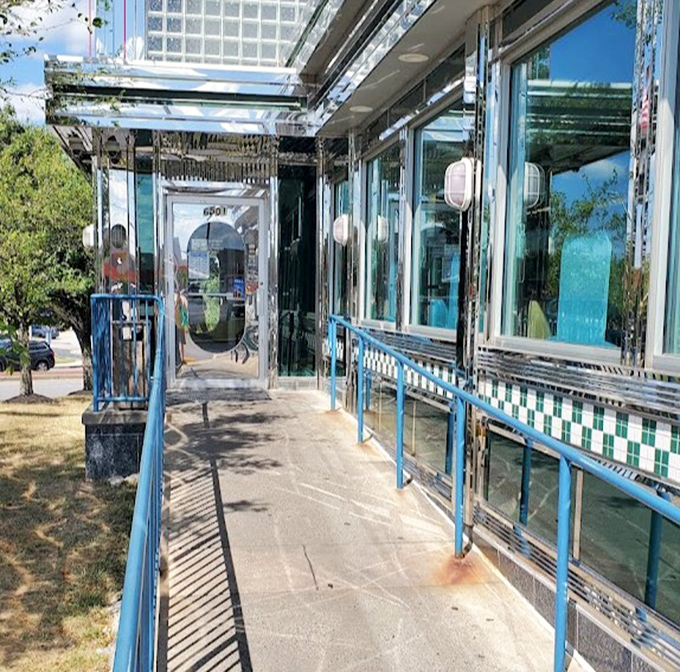 The entrance ramp gleams in the sunlight, a chrome-lined pathway to comfort food paradise that promises "good things this way."