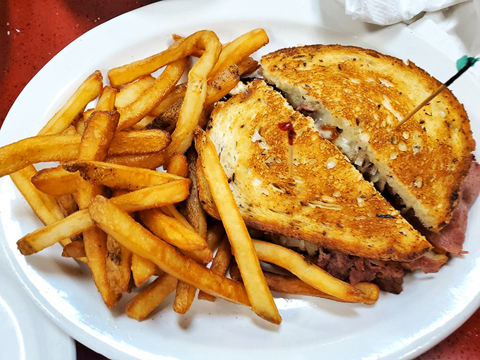 A proper Reuben should require both hands and several napkins. This golden-grilled masterpiece passes the test with flying colors.