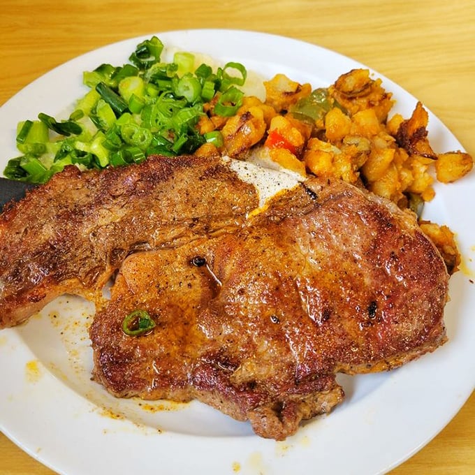 A pork chop that deserves its own ZIP code, with potatoes and green onions playing perfect supporting roles. Meat and potatoes elevated to poetry.