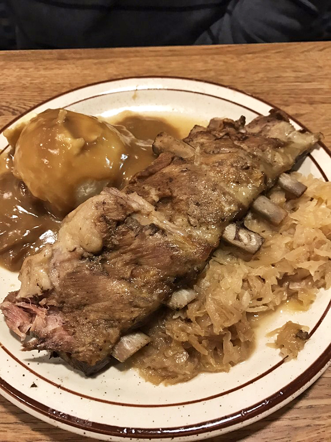 Ribs nestled against sauerkraut with gravy-topped mashed potatoes standing by. A plate that honors Ohio's German heritage with every savory bite.