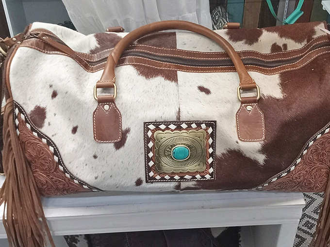 Western-inspired leather and cowhide bag that whispers tales of rodeos and ranches, bringing a touch of cowboy chic to the Sunshine State.