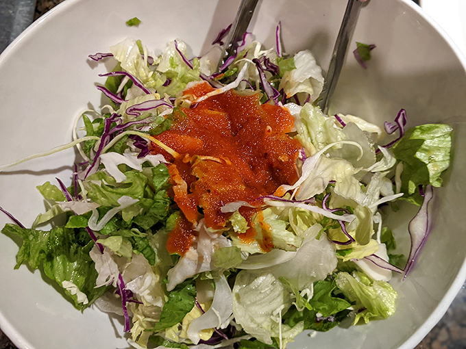 This isn't just salad; it's a palate cleanser between meat courses, dressed with gochujang for a reminder of why you came.