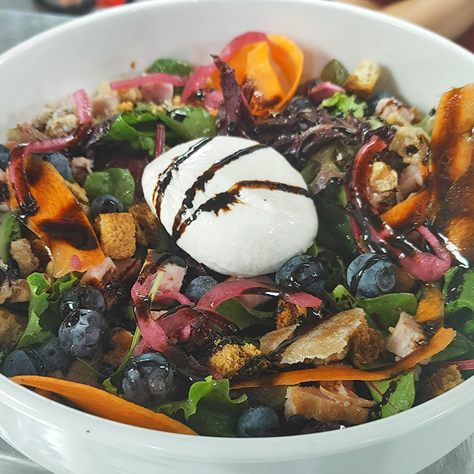 A salad that actually excites &ndash; fresh greens playing host to a party of blueberries, pickled onions, and a creamy cheese centerpiece.
