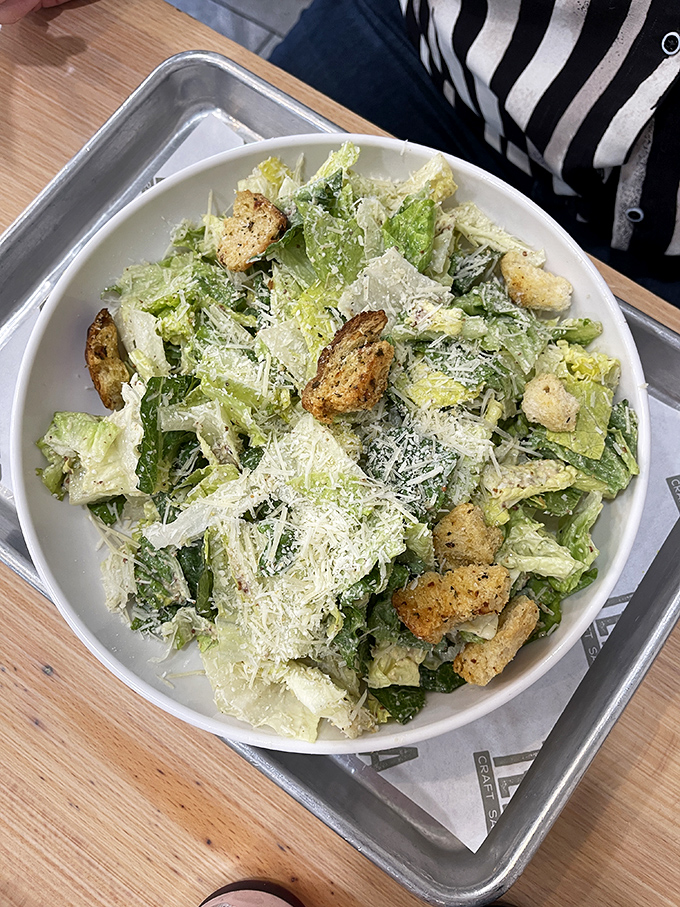 This Caesar salad isn't just a supporting actor &ndash; it's ready for its close-up with perfectly dressed greens and house-made croutons.
