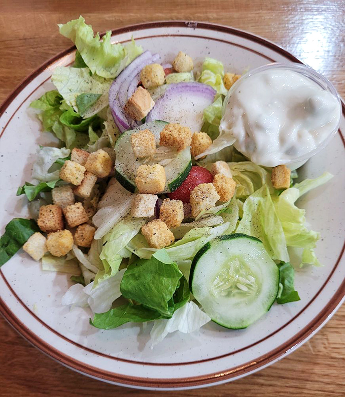 Fresh greens topped with croutons like little golden soldiers marching across a battlefield of crisp lettuce and garden vegetables.