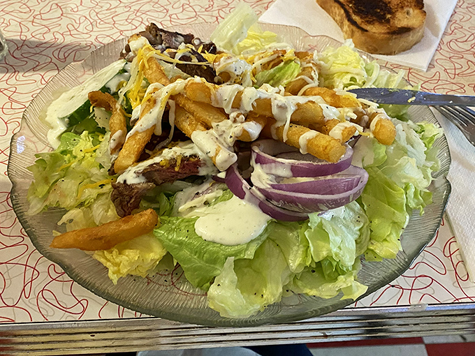 A salad that answers the eternal question: "Can healthy food be exciting?" with a resounding "Yes!" and a sprinkle of crispy fries for good measure.